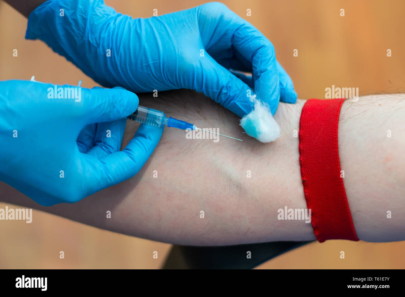 the doctor administer the iv treatment to a man Stock Photo - Alamy