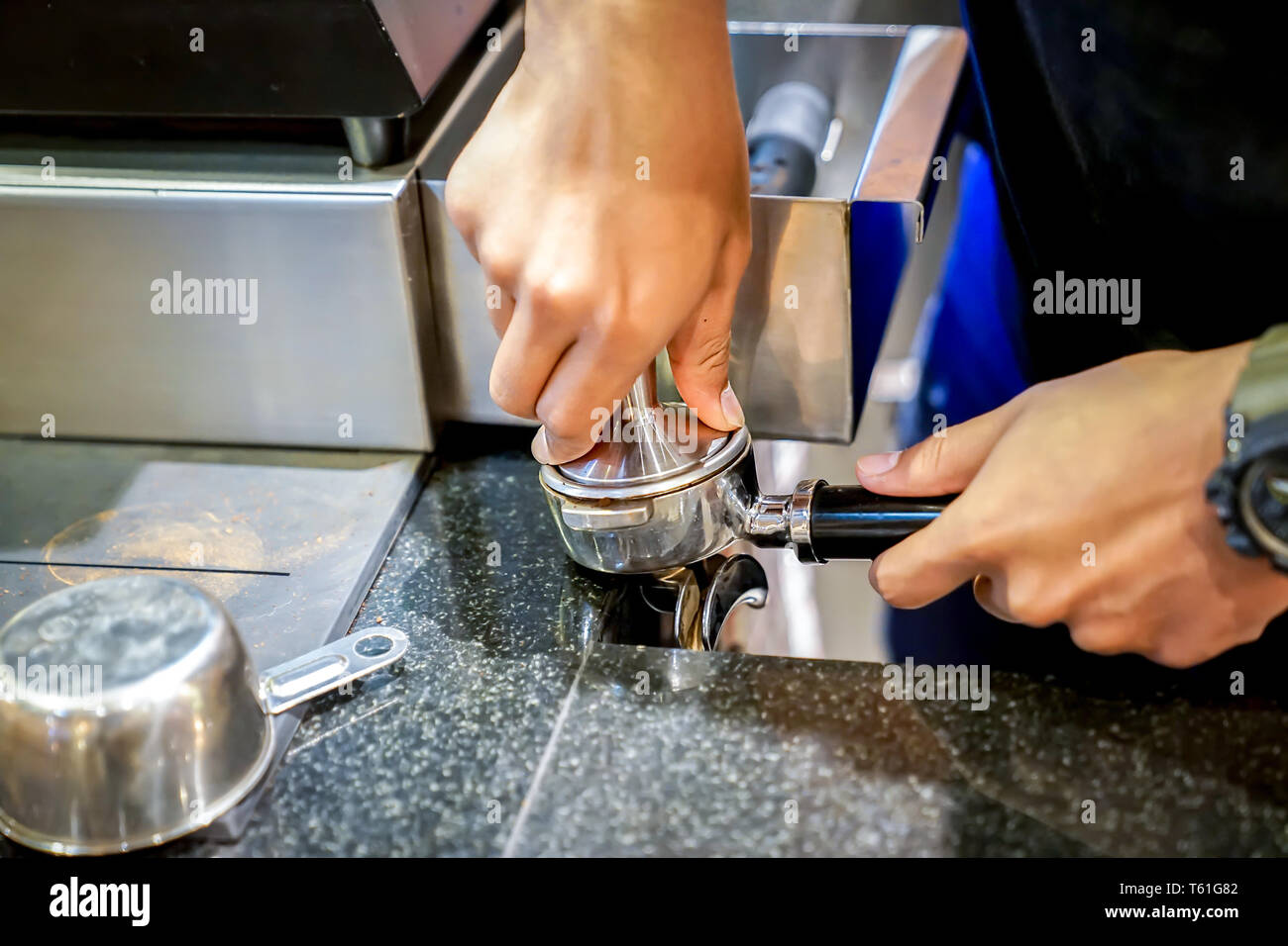 Barista is processing; push the coffee bean in the equipment and tool ...
