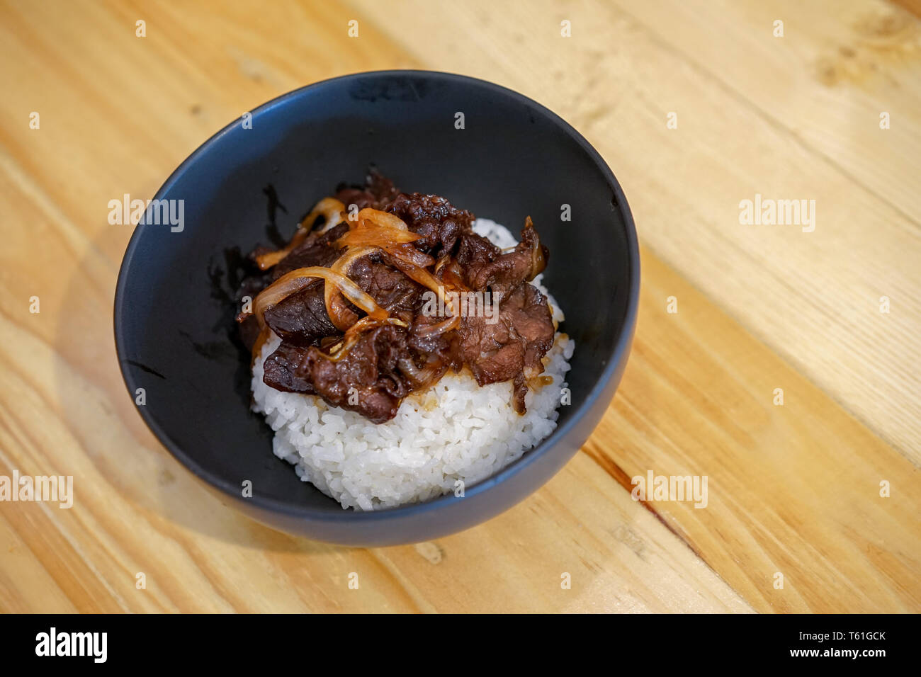 Grilled meat on the Japanese rice with wood table background Stock ...