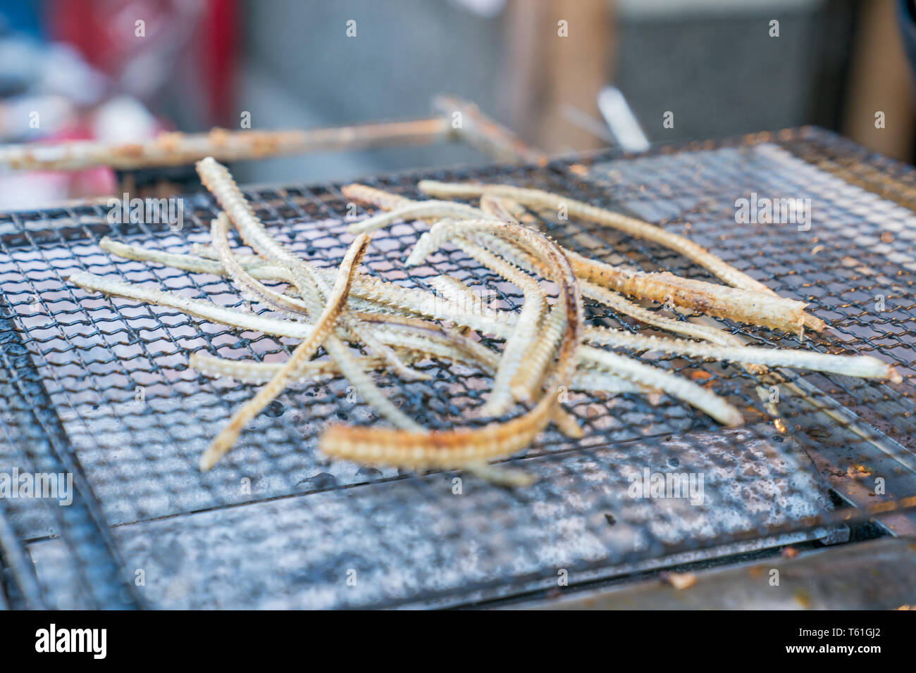 Unagi (eel / fish) bone is grilled on the electronic grill machine, Japanese tradition street ...