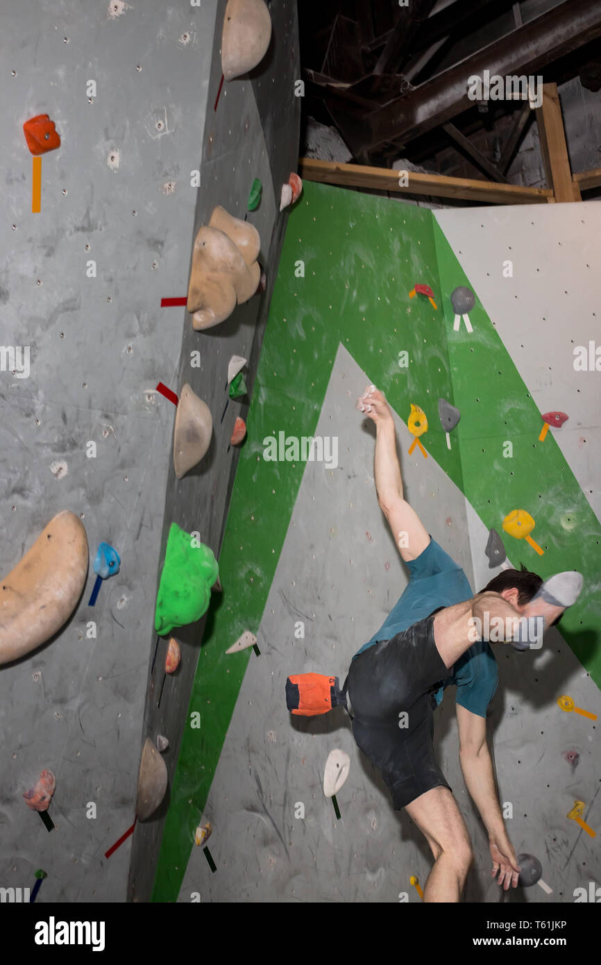 rock climber falls off the wall in the boulder hall Stock Photo - Alamy