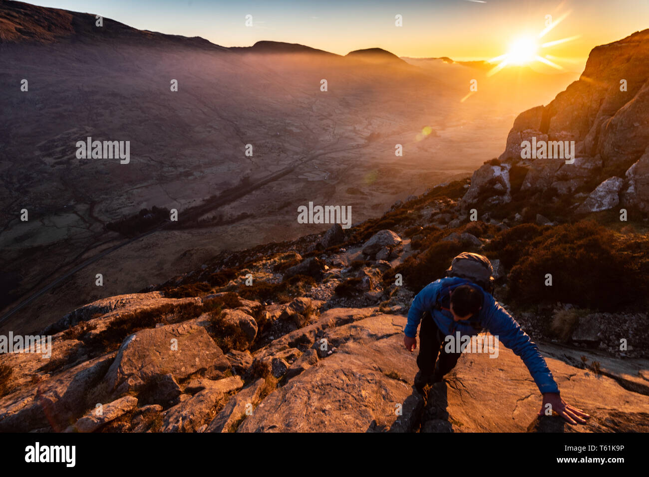 person scrambling climbing welsh mountain try fan in the early morning ...