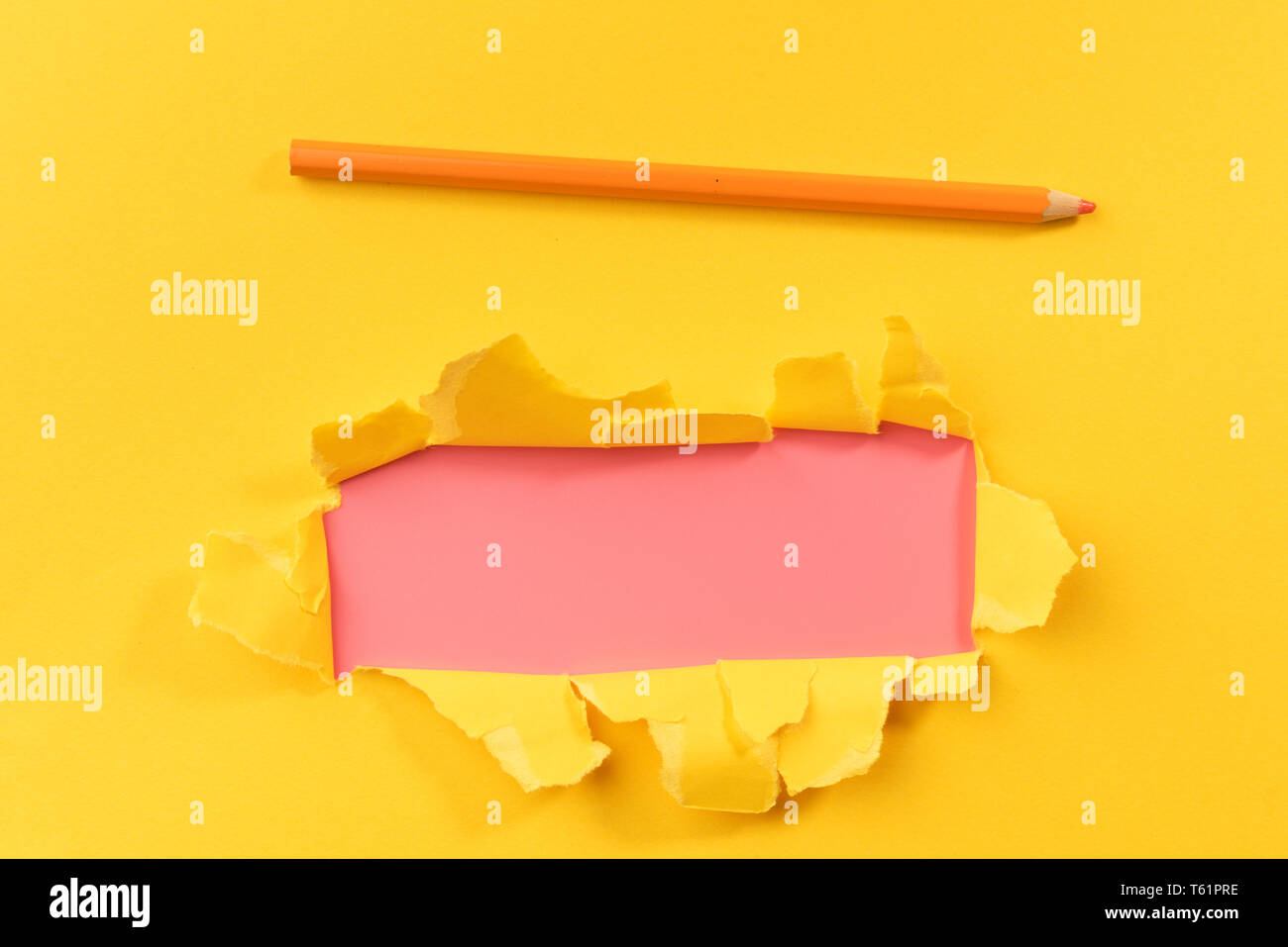 Yellow torned paper over pink background with pencil Stock Photo - Alamy