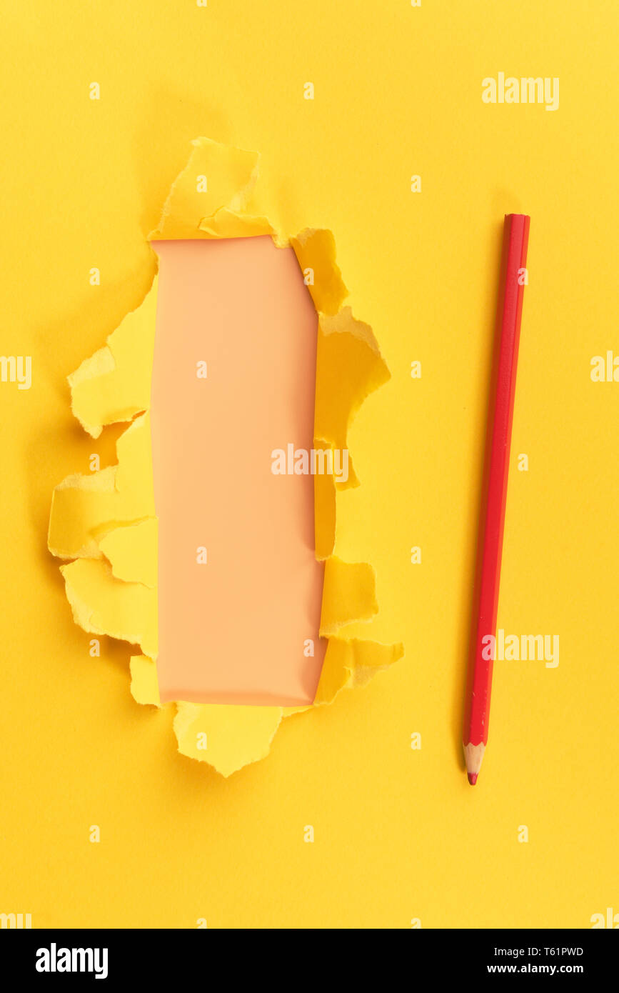 Yellow torned paper over orange background with pencil Stock Photo - Alamy