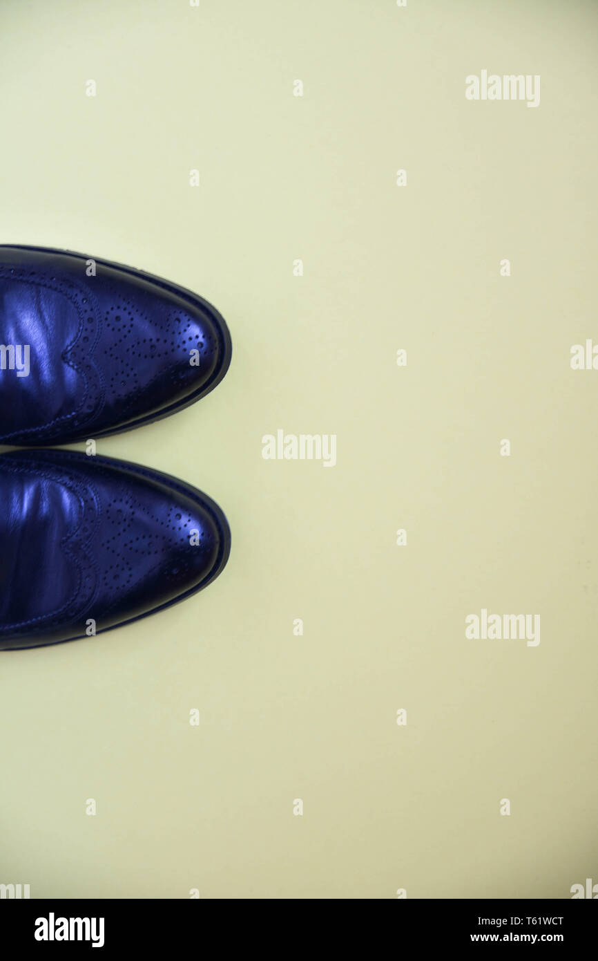 men's shoes on a yellow background Stock Photo - Alamy