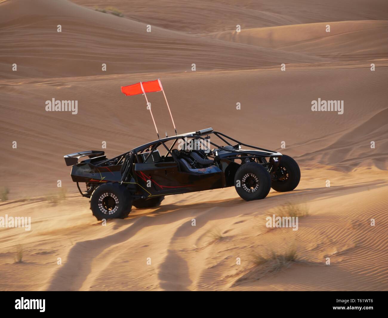 Desert buggy drives action-packed over desert dunes Stock Photo - Alamy