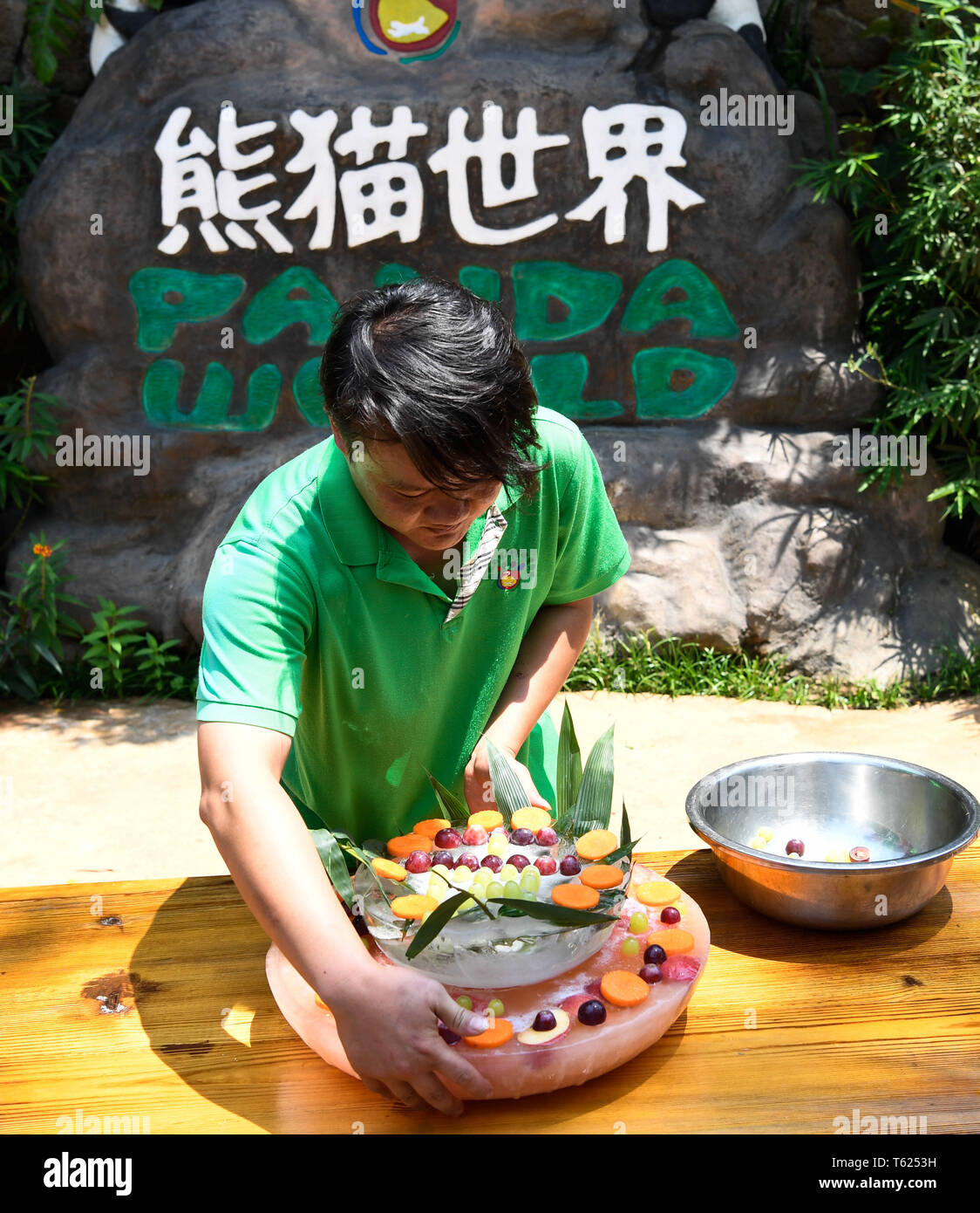 Haikou, China. 28th Apr, 2019. A staff member prepares icy cake for ...