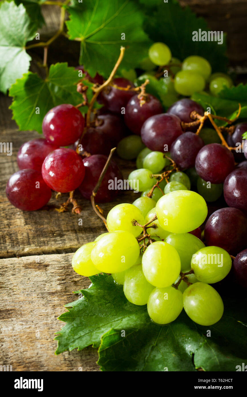 Mix grapes on rustic wooden table. The concept of nutrition health ...