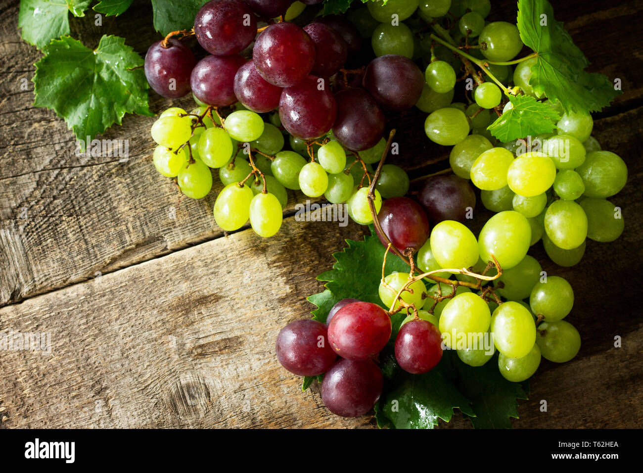 Mix grapes on rustic wooden table. The concept of nutrition health ...