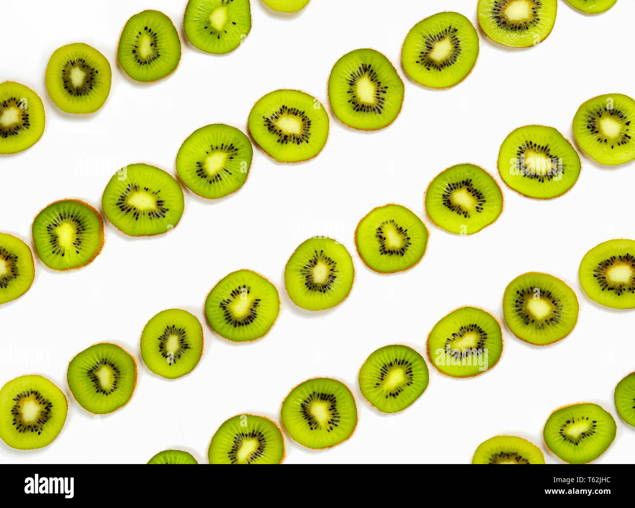 Kiwi fruit slice in diagonal row as pattern. Colorful food pattern for ...