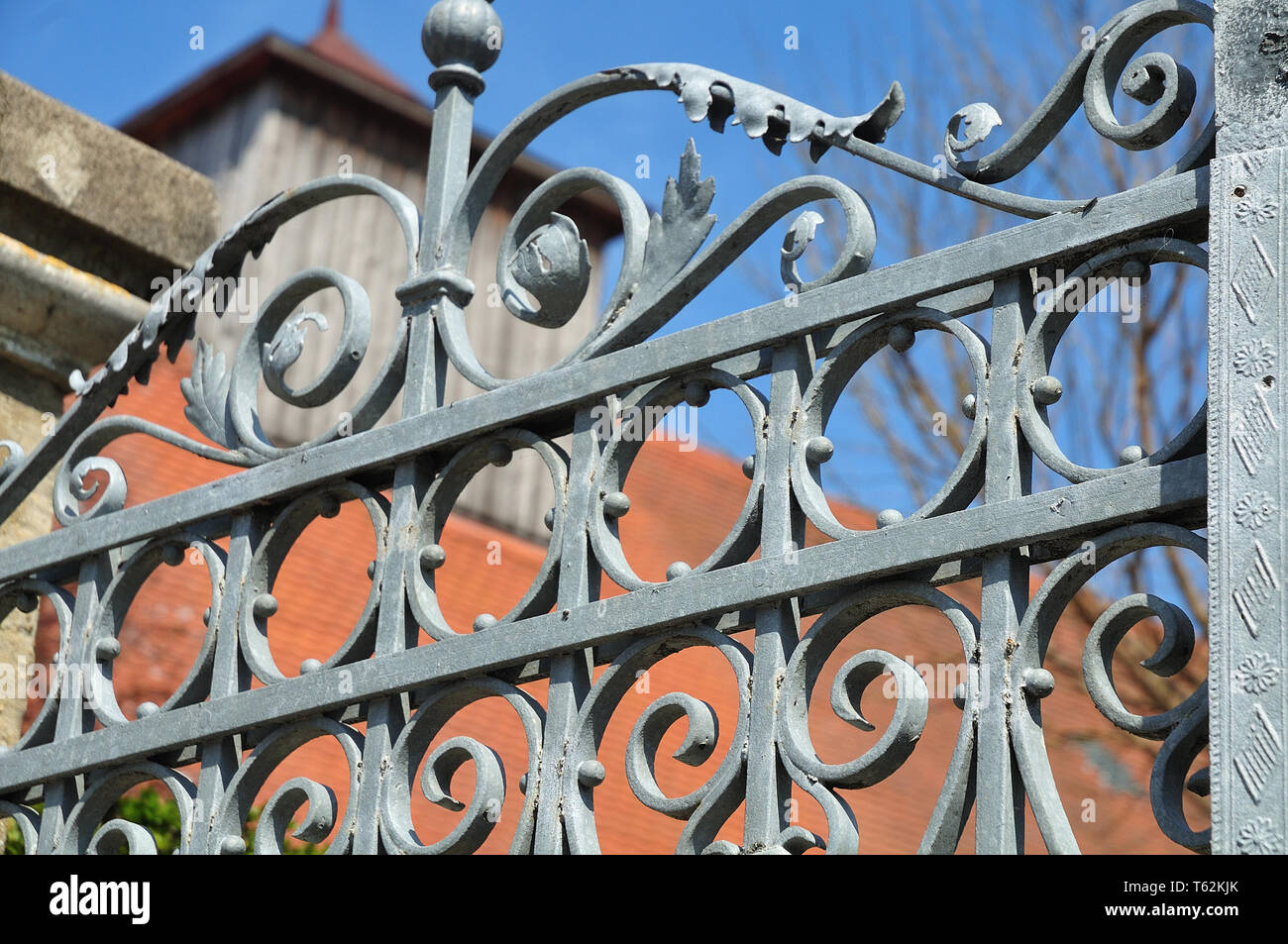 side view to old wrought-iron gate with ornaments in leaf shape Stock ...