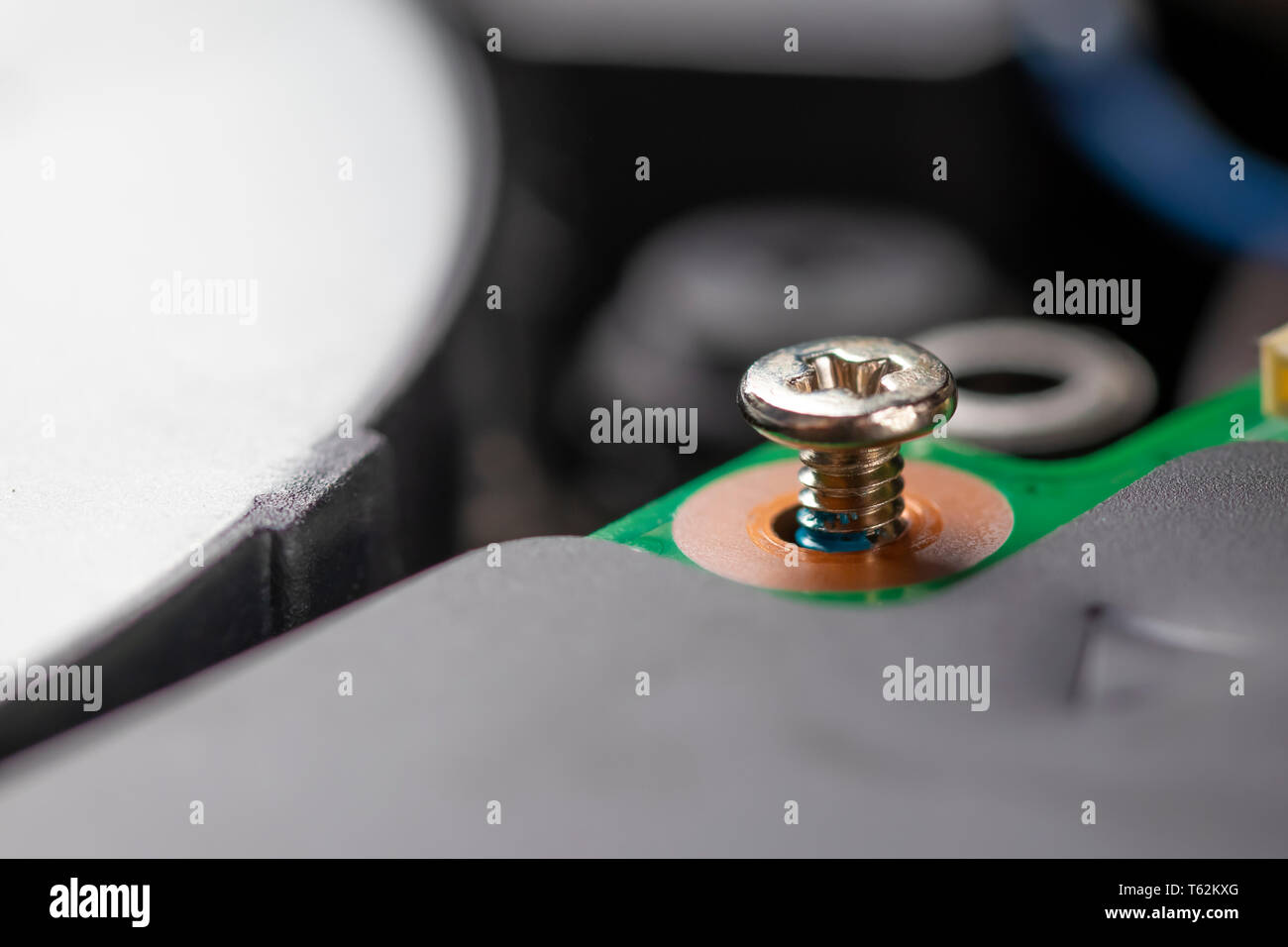 A shiny metal bolt securing the processor board, unscrewed in half ...