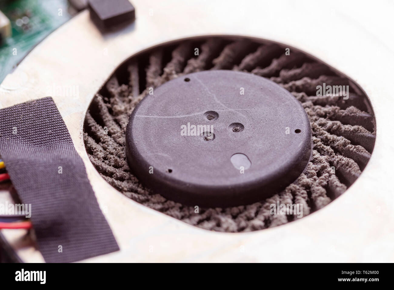 Dusty fan of a laptop close up. Disassembling and cleaning the laptop ...