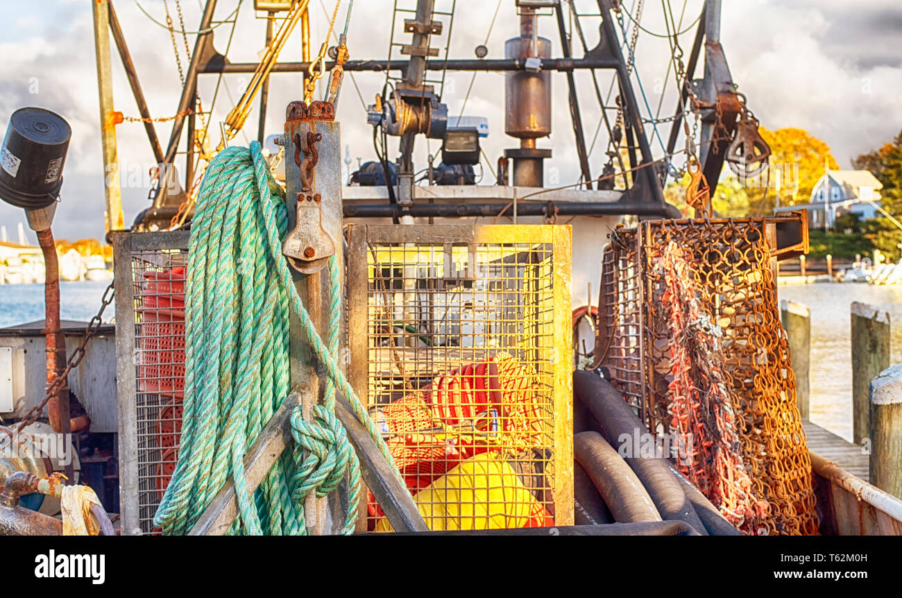 The fishing and lobster traps and rigging on the back of a fishing boat ...