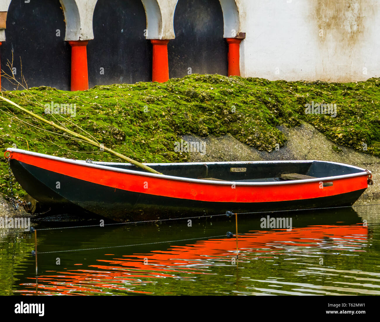 Classic Japanese rowing boat docked at the water side, recreational ...