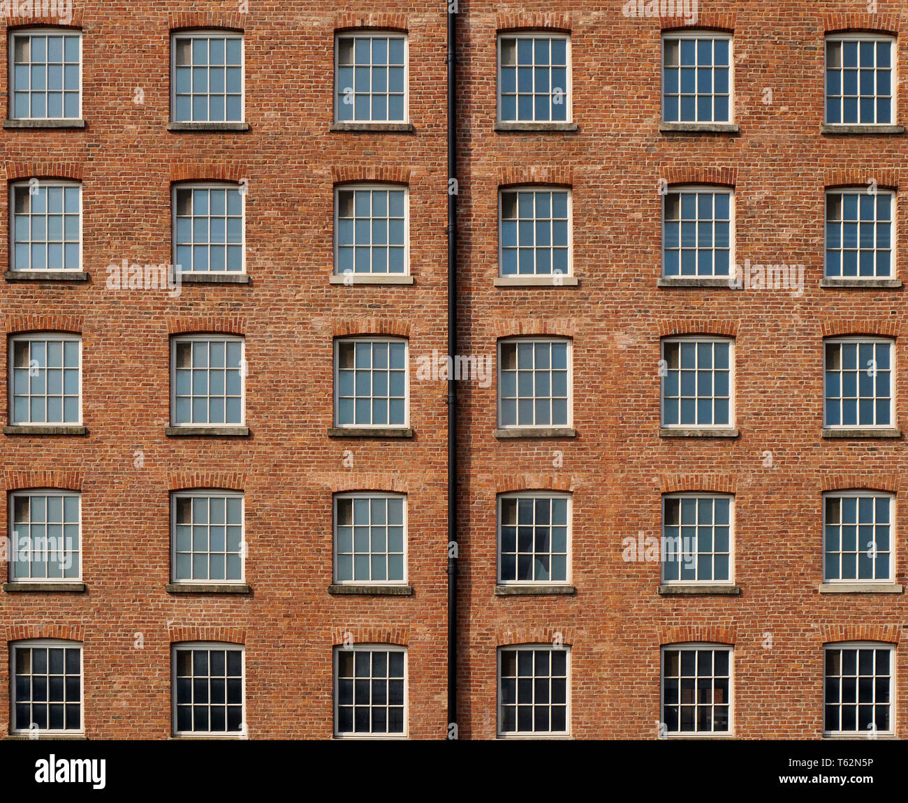 Lots of windows on restored cotton mill in Manchester UK Stock Photo ...