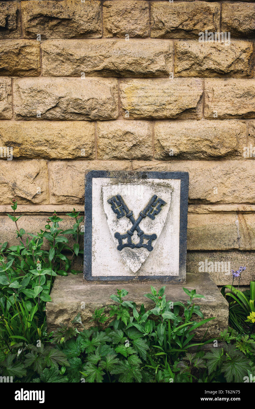 Crossed Keys stone leaning against church wall at St Peter's church in ...