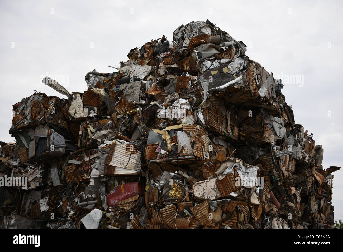 Low angle view of a large pile of stacked compacted smashed compressed ...