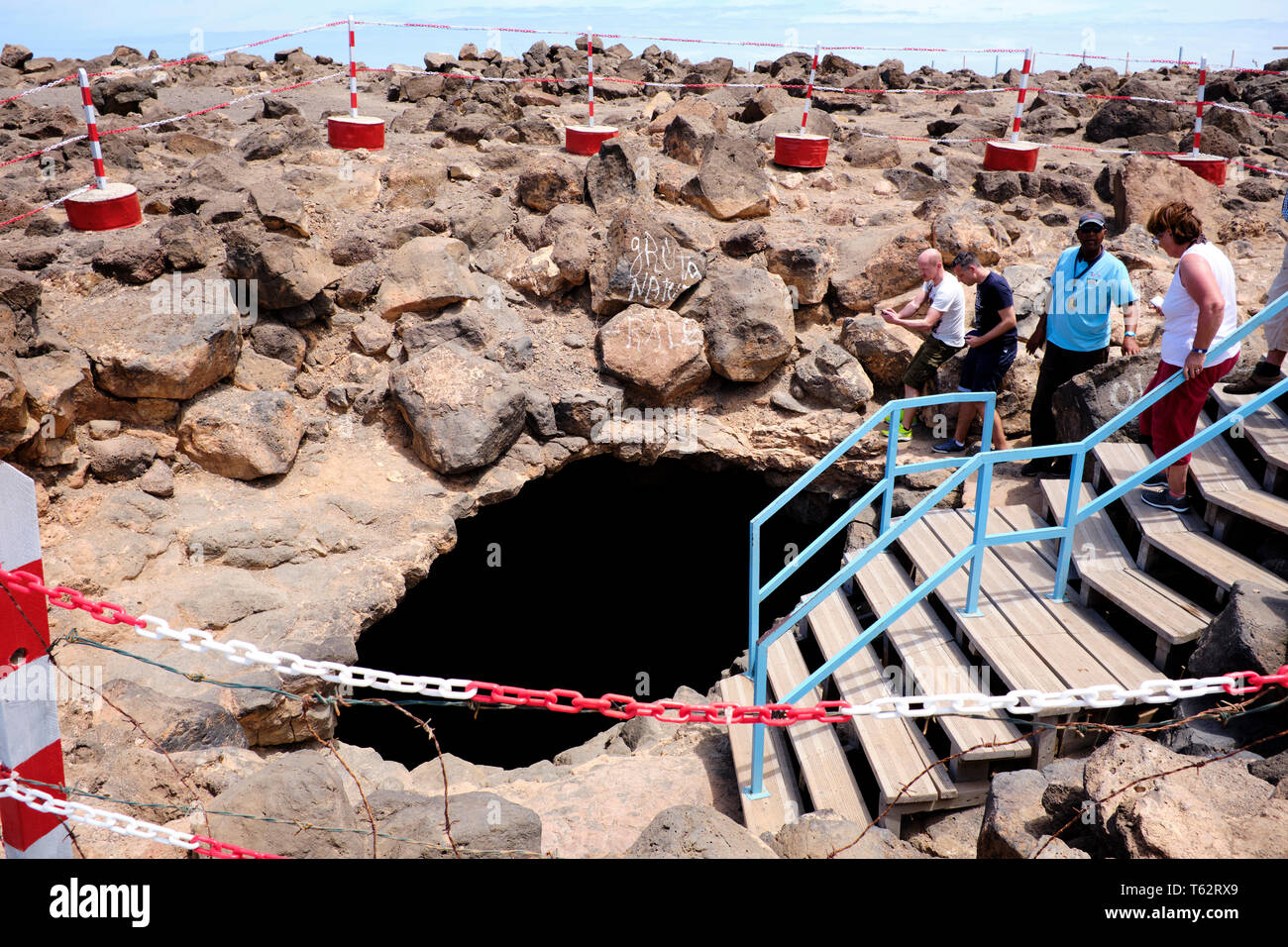 Tourists Looking Down Into The Natural Phenomena Known As The Blue Eye ...