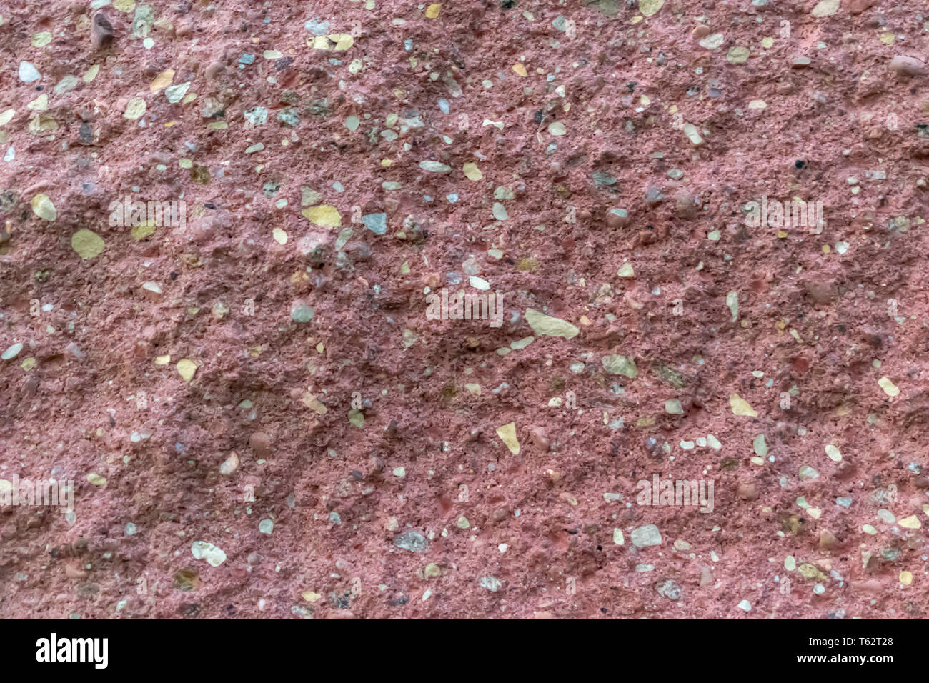 background texture of a red stone poured into a monolith of concrete ...