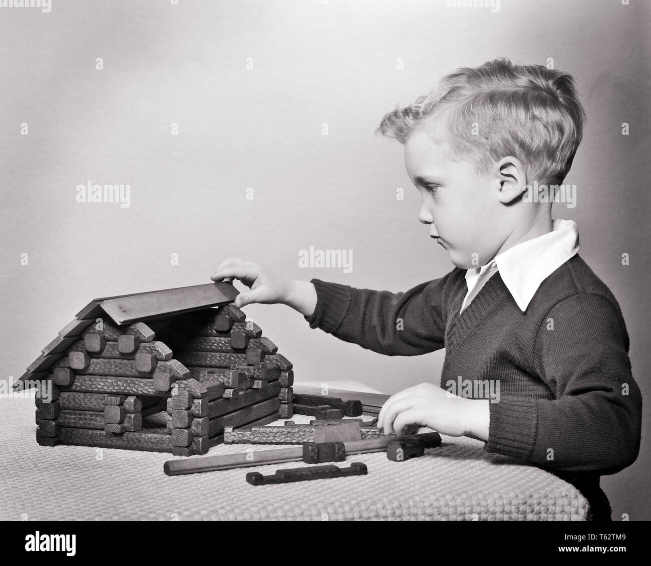 1950s INTENT YOUNG BLOND BOY PLAYING BUILDING MODEL LOG CABIN WITH ...