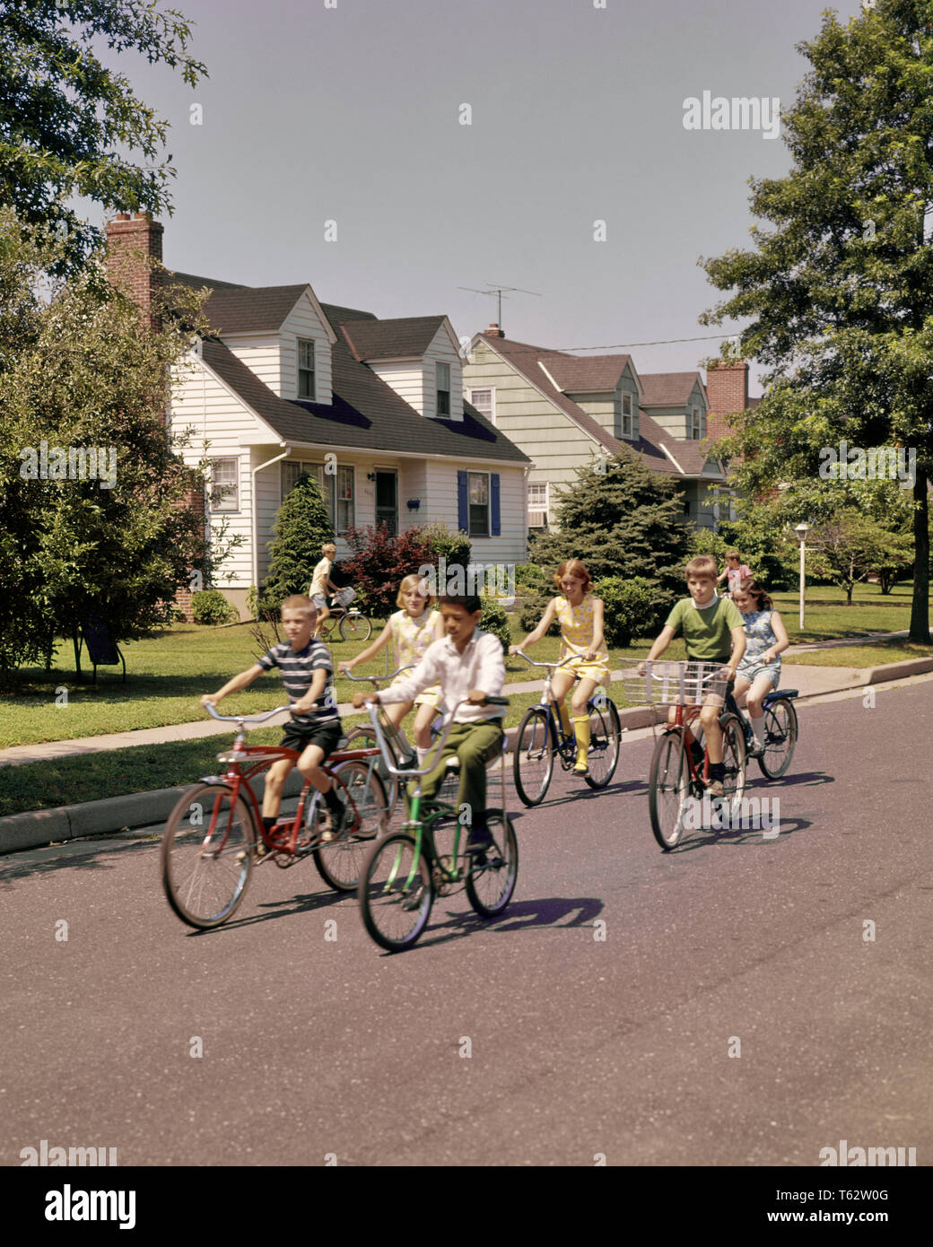 1960s 1970s GROUP CHILDREN RIDING BIKES DOWN SUBURBAN STREET - kb7278 ...