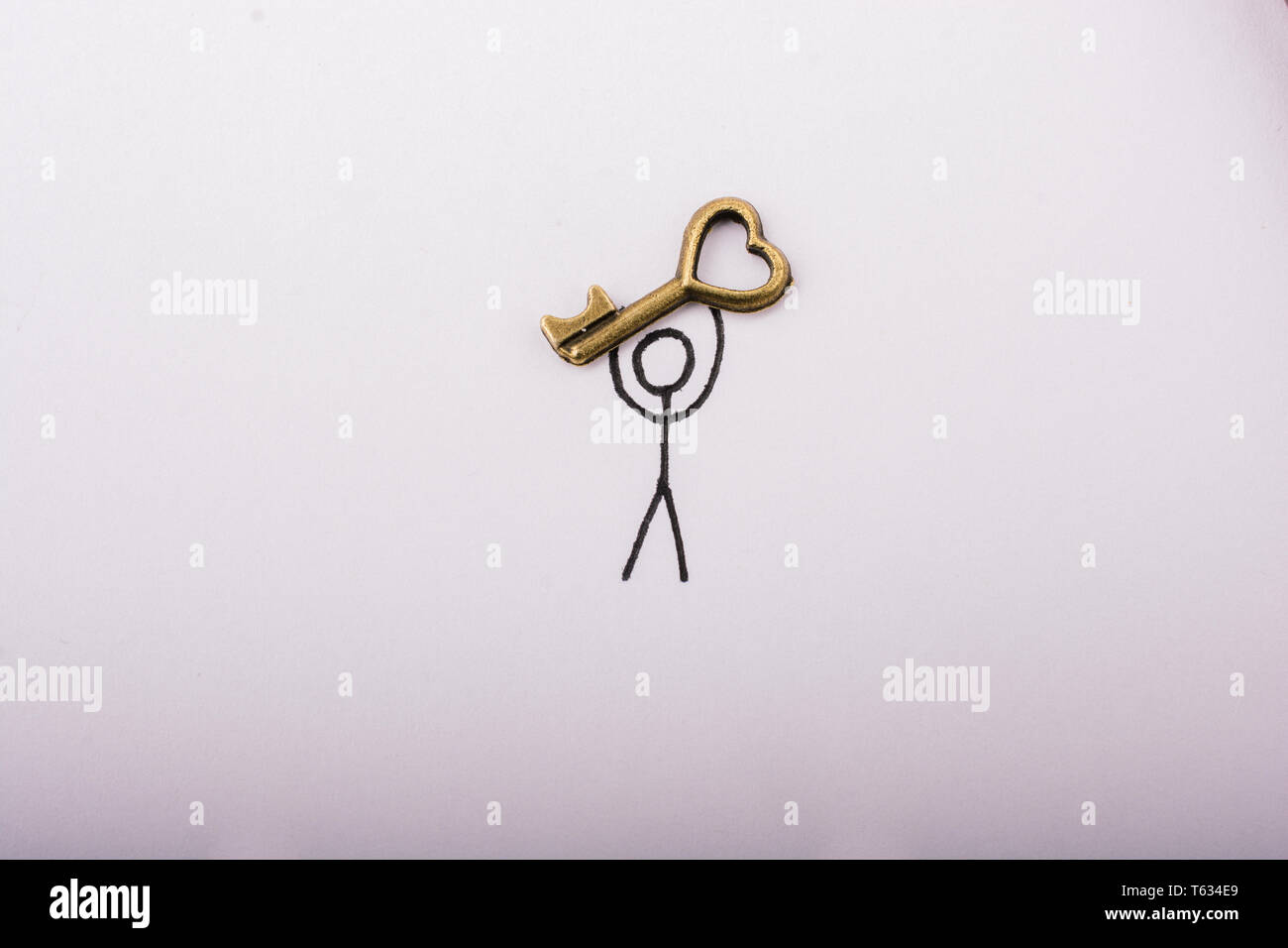 Man carrying a heart shaped key on white background Stock Photo - Alamy