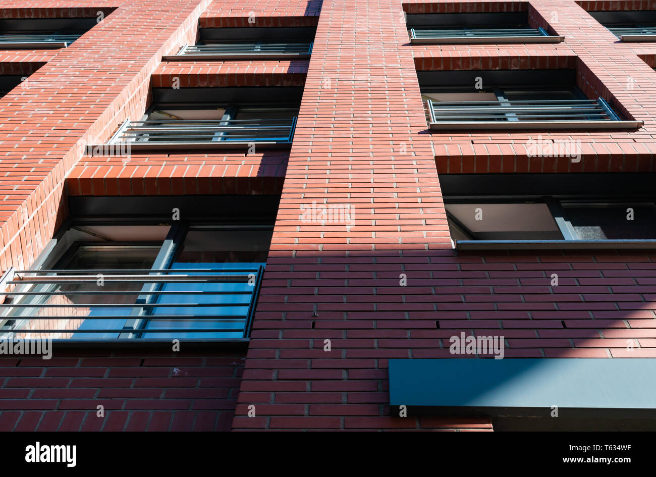 View looking up at brick apartment building. Modern European building ...
