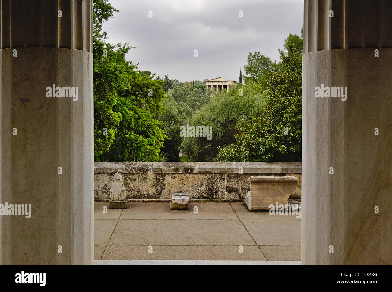 View of trees and cloudy sky behind two columns in Stoa of Attalos in ...
