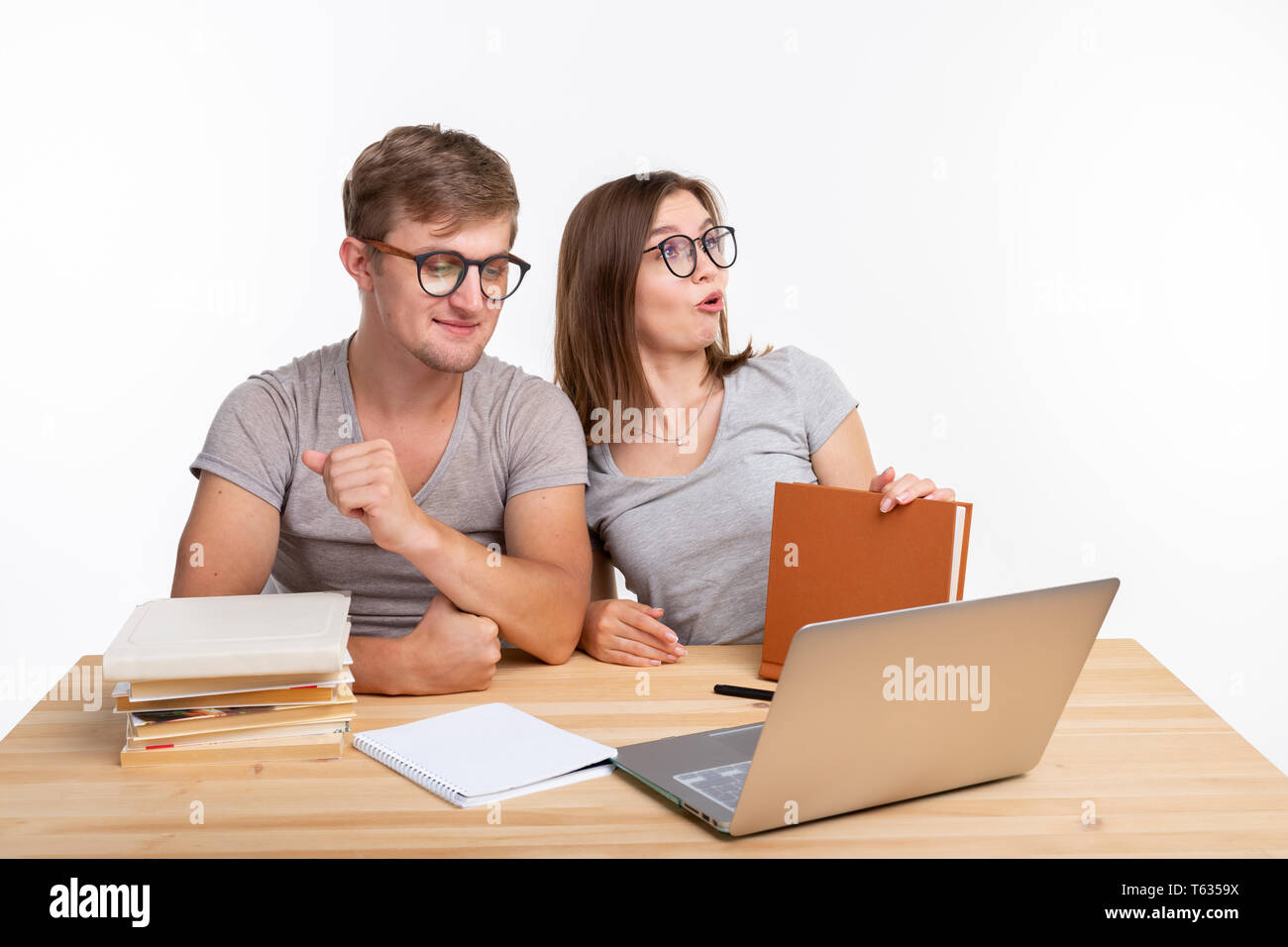 Nerds, study, people concept - a couple of people look at the laptop ...