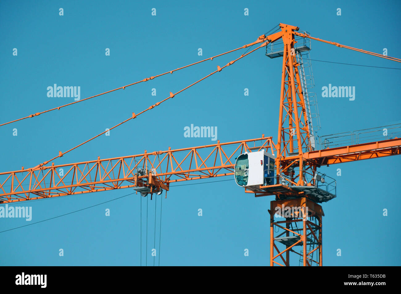 lifting tower crane against the blue sky. construction Stock Photo - Alamy