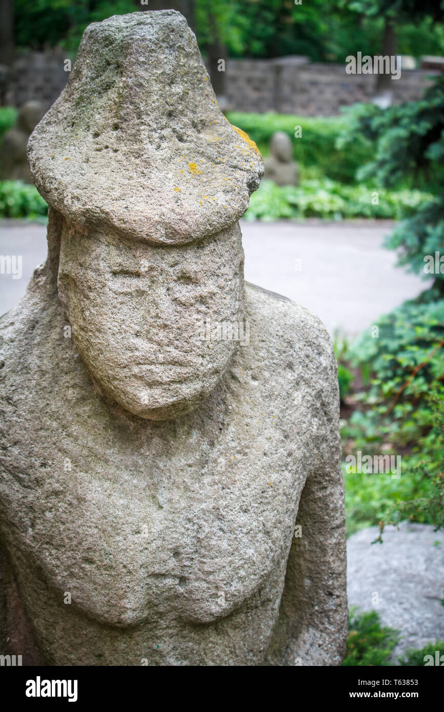 Ancient statue of Polovtsian stone woman or boundary stone in the city ...