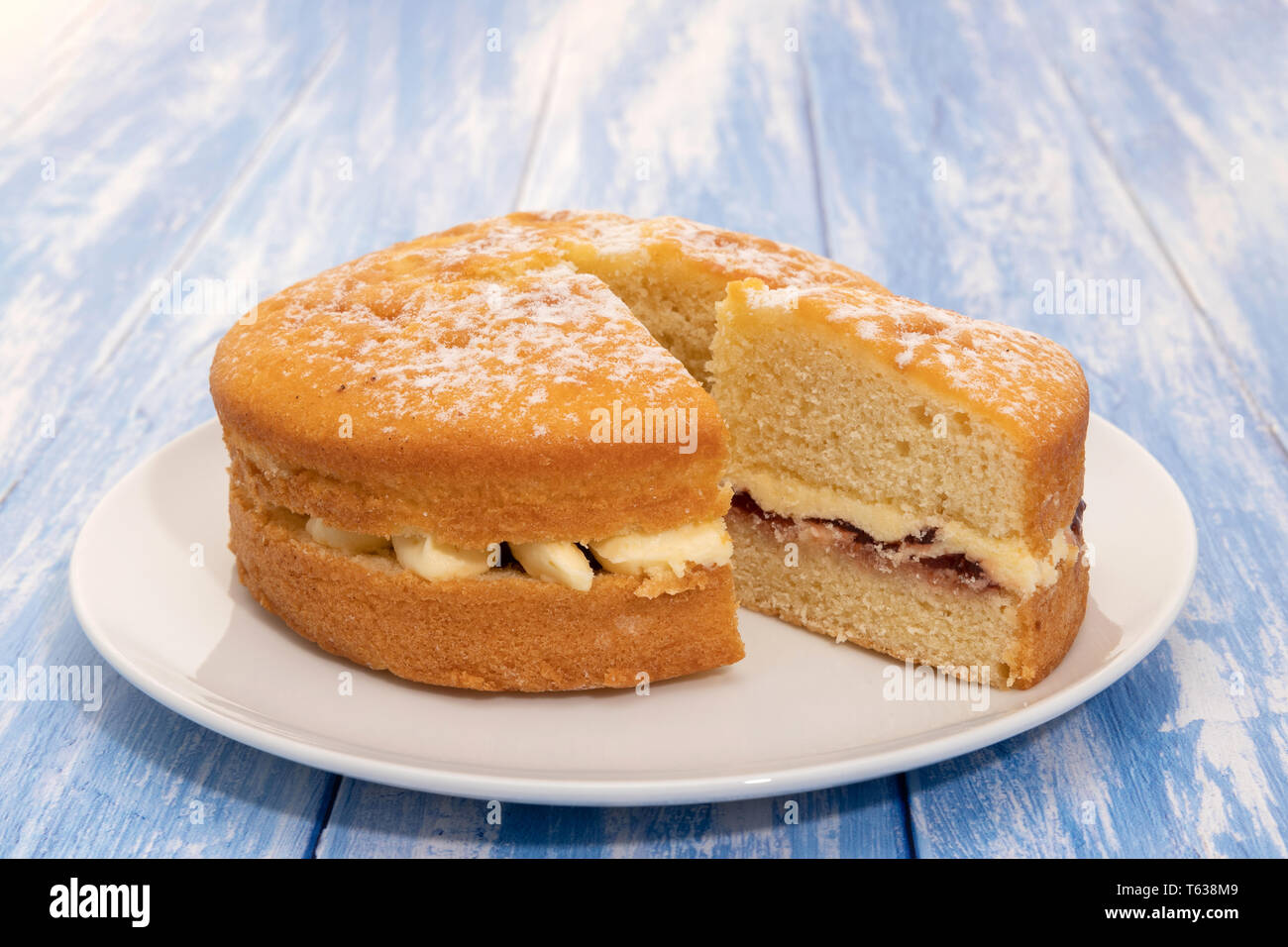 Delicious Victoria sponge cake with a slice removed Stock Photo - Alamy