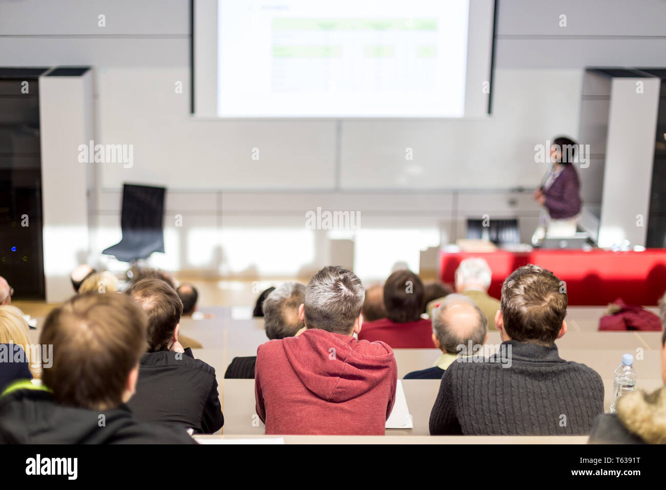 Woman giving academic presentation in lecture hall at university Stock ...