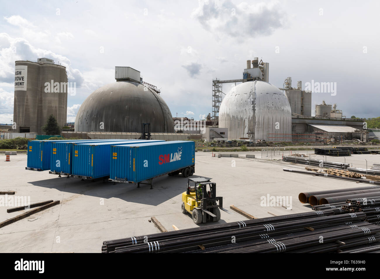 Seattle, Washington: A forklift driver stacks pipe bundles at Ash Grove ...