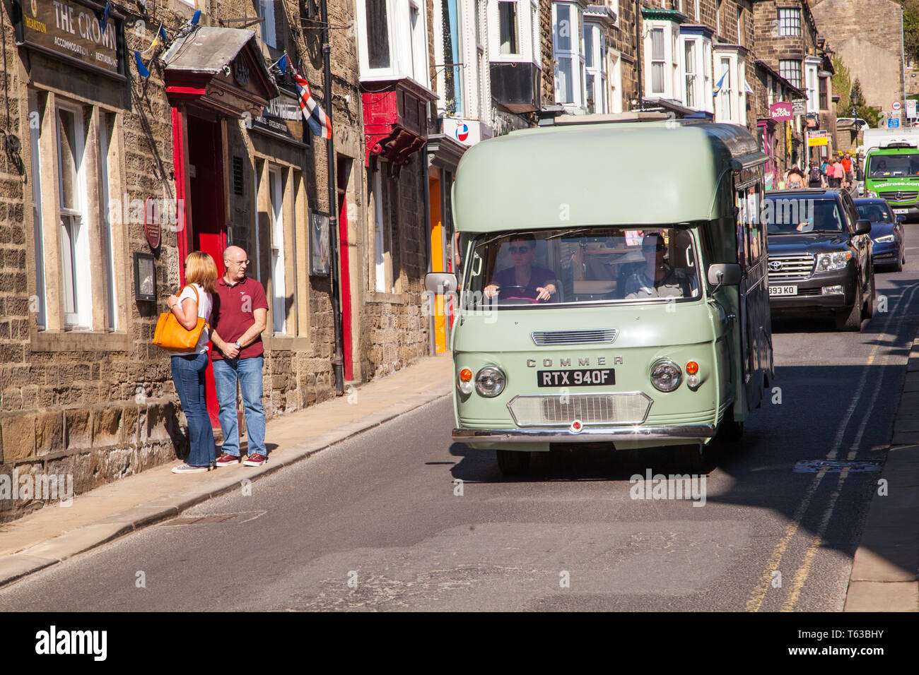Old classic Commer camper van driving through the town of Pateley ...