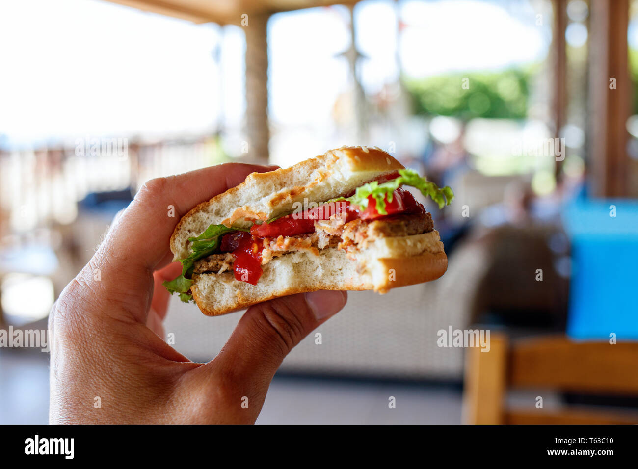 Fast food burger with a bite taken out of it Stock Photo - Alamy