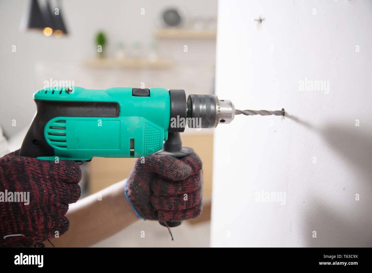 hands with gloves using electric drill Stock Photo - Alamy