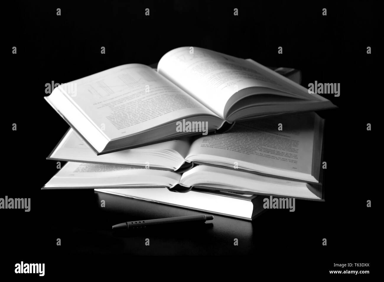 books on black background with pen for background use Stock Photo - Alamy
