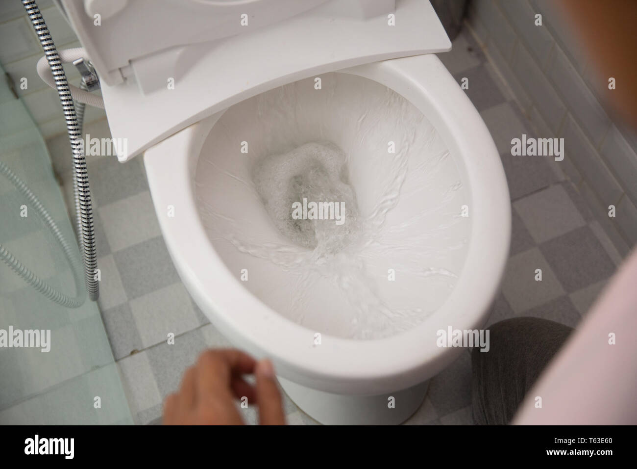 water flush on toilet Stock Photo - Alamy