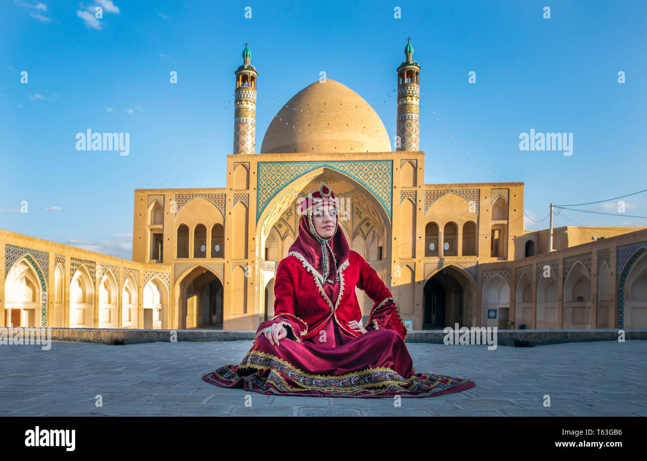 young beautiful iranian lady dressed in red traditional dress in a ...