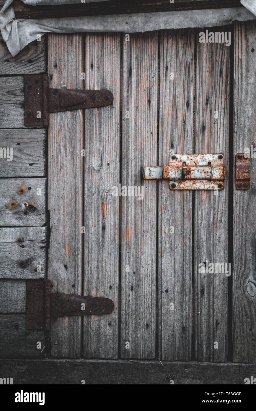 Old wooden door and rusty deadbolt in a small barn Stock Photo - Alamy
