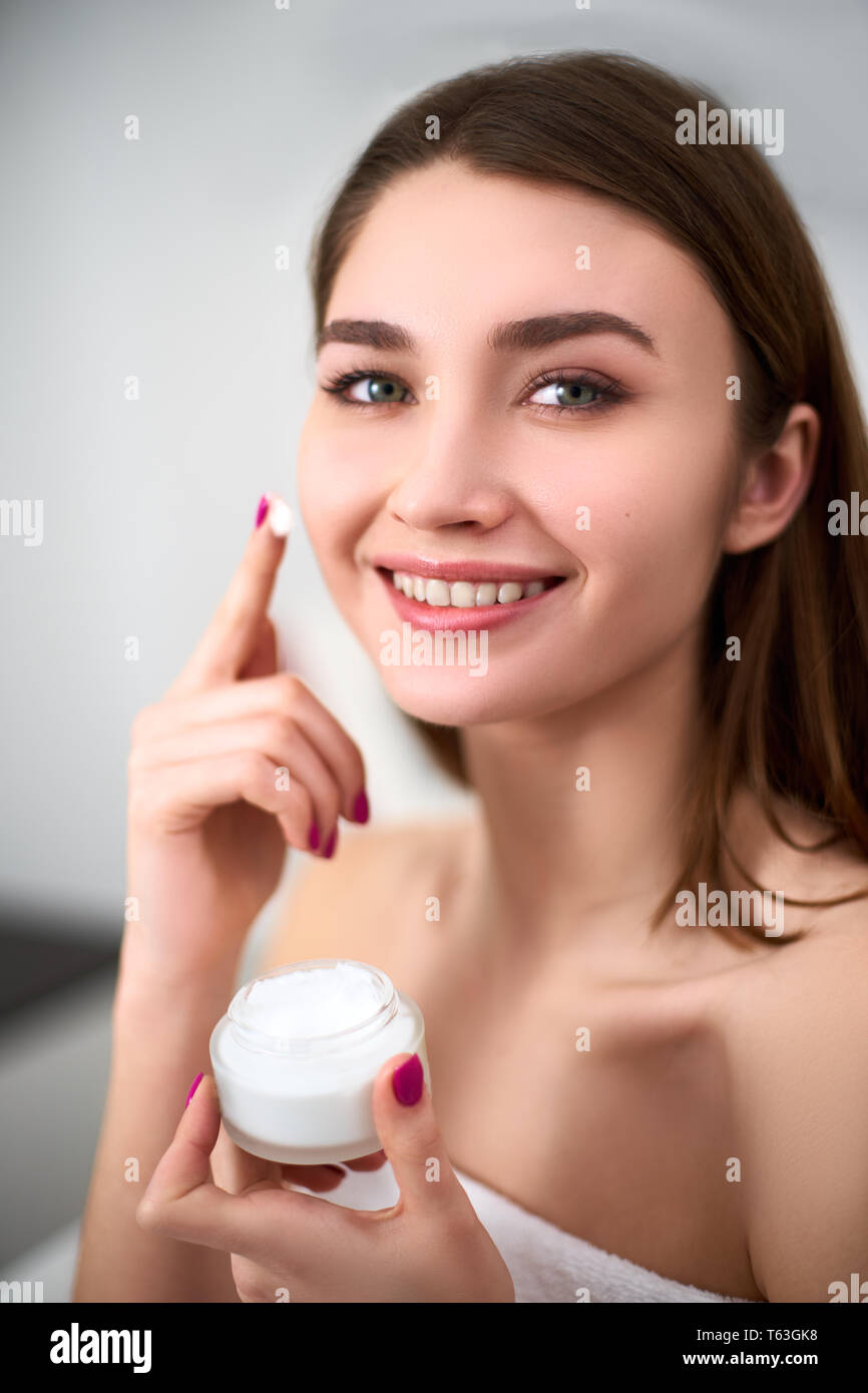 Woman applying face cream hi-res stock photography and images - Alamy