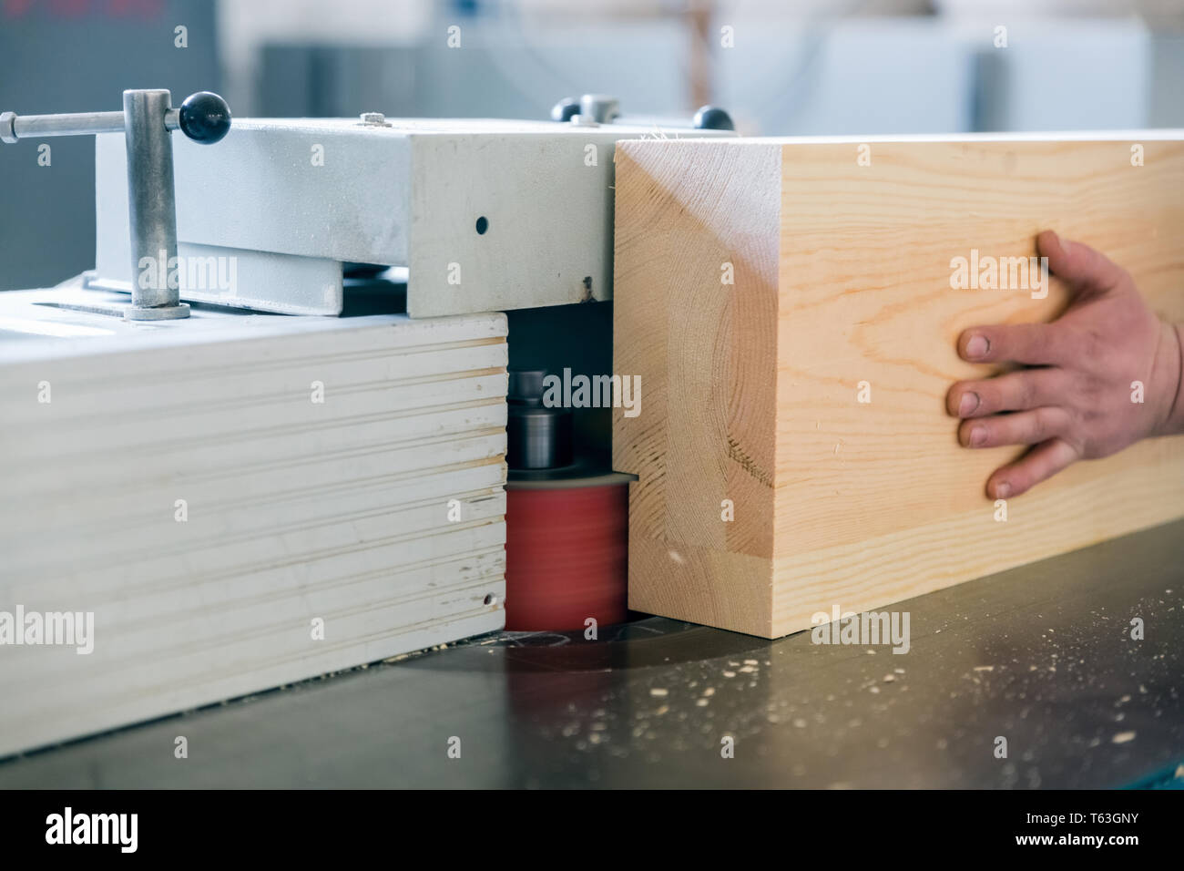 Processing of wooden beams on the machine. Working process Stock Photo ...