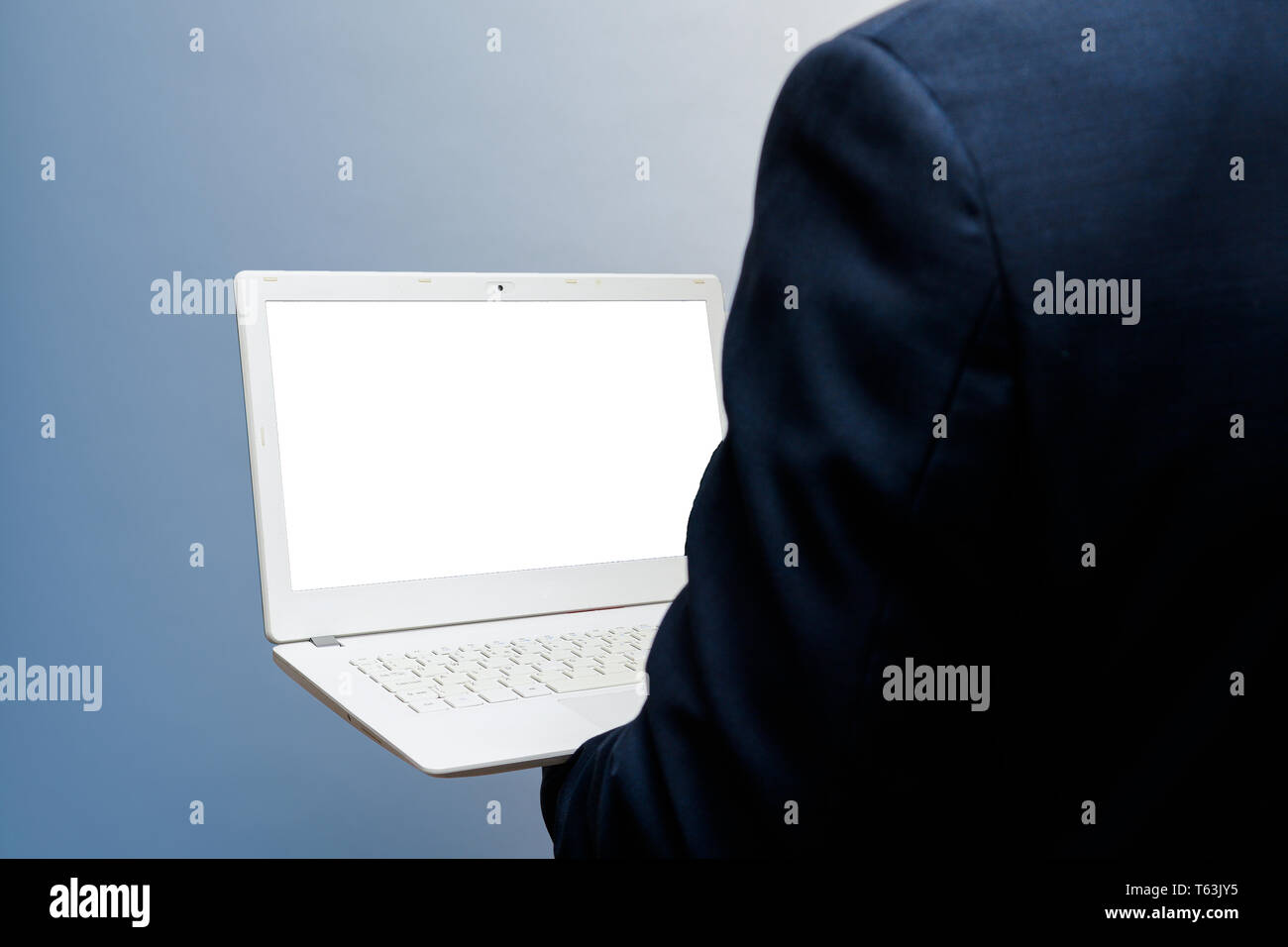 Man using laptop with blank white screen, shot from over shoulder Stock ...
