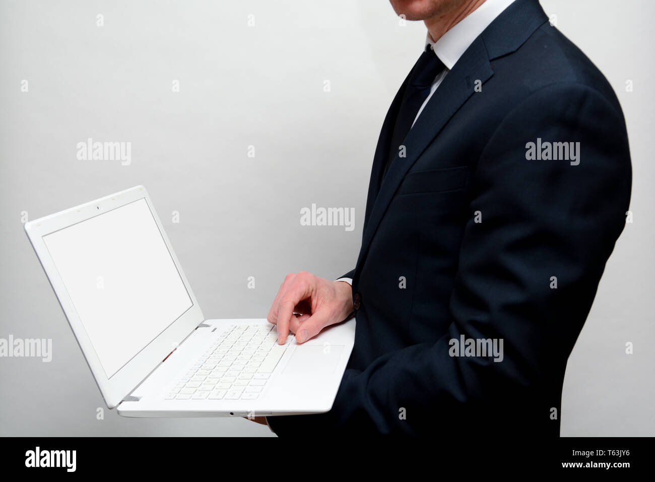 Man using laptop with blank white screen, shot from over shoulder Stock ...