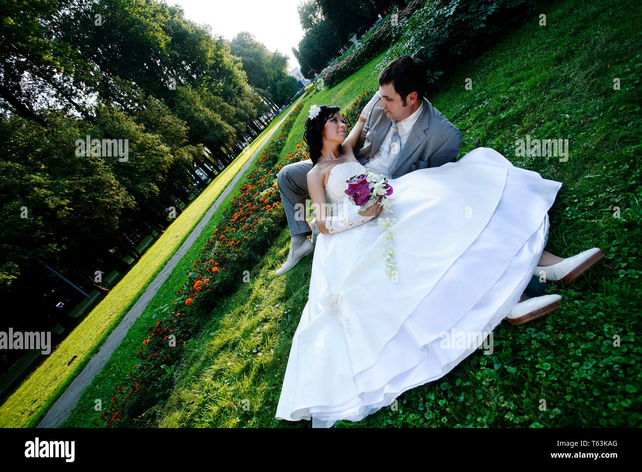 09/07/2008 Moscow Russia / Groom and bride lying on grass and look into ...