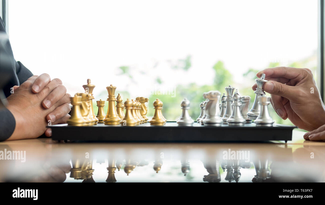 businessman playing chess game figures on wooden table for analysis new ...