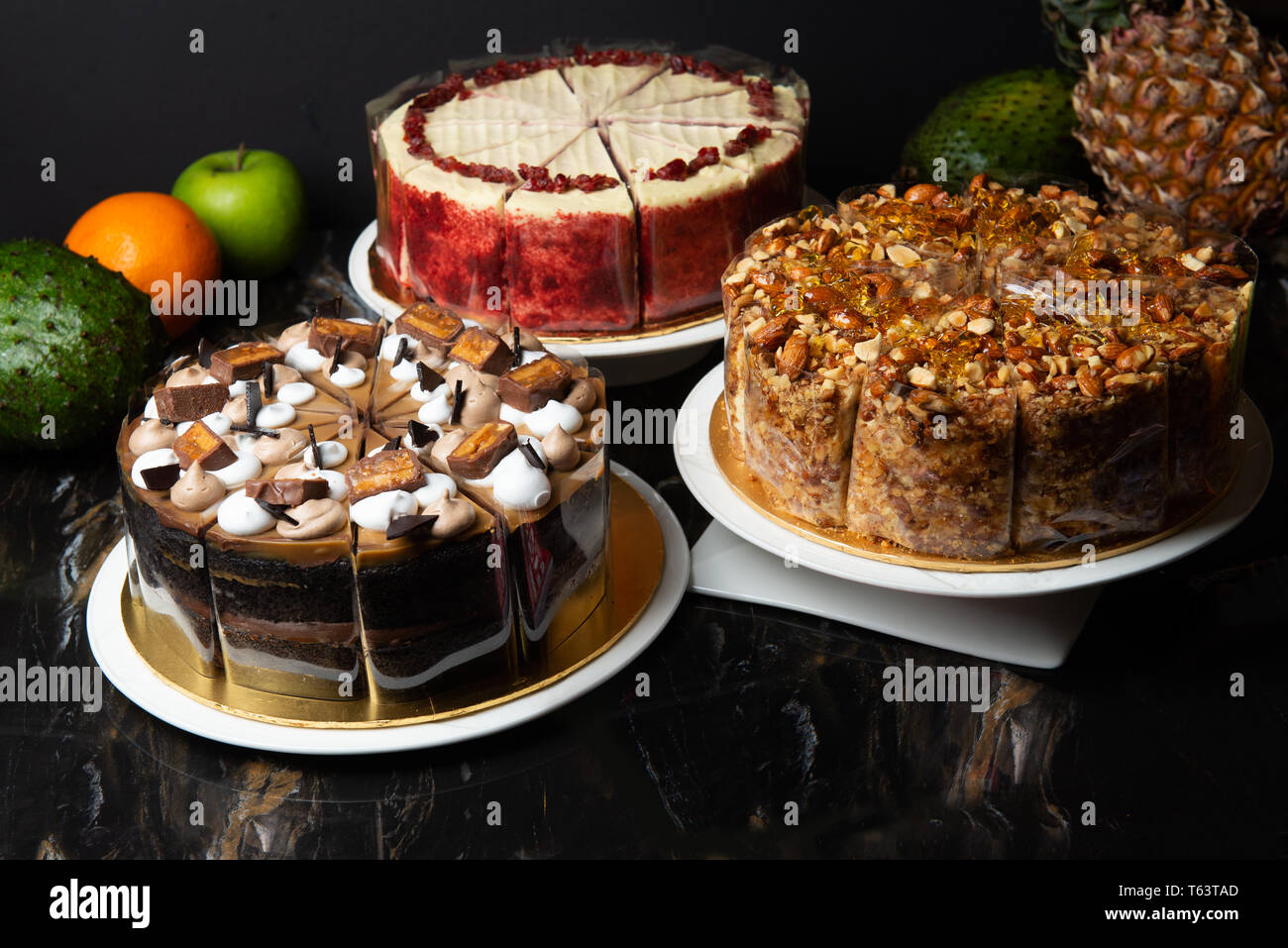 various cakes on display with dark background Stock Photo - Alamy