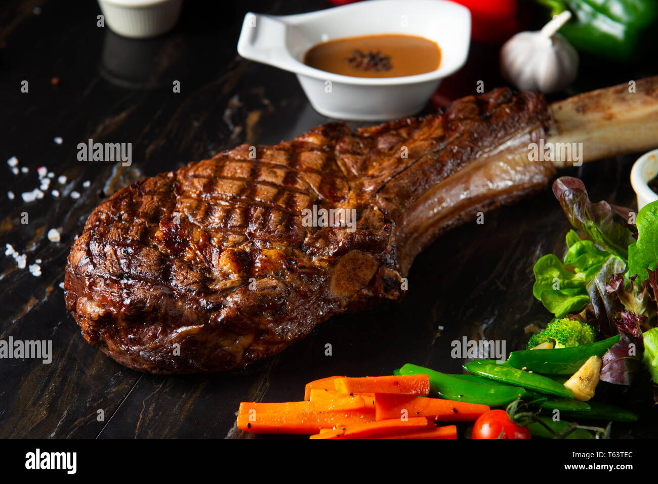 beautifully seared tomahawk steak, medium rare to rare Stock Photo - Alamy